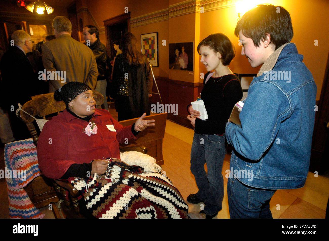 Vicki Sanders, left, who is homeless, discusses her work with art show ...