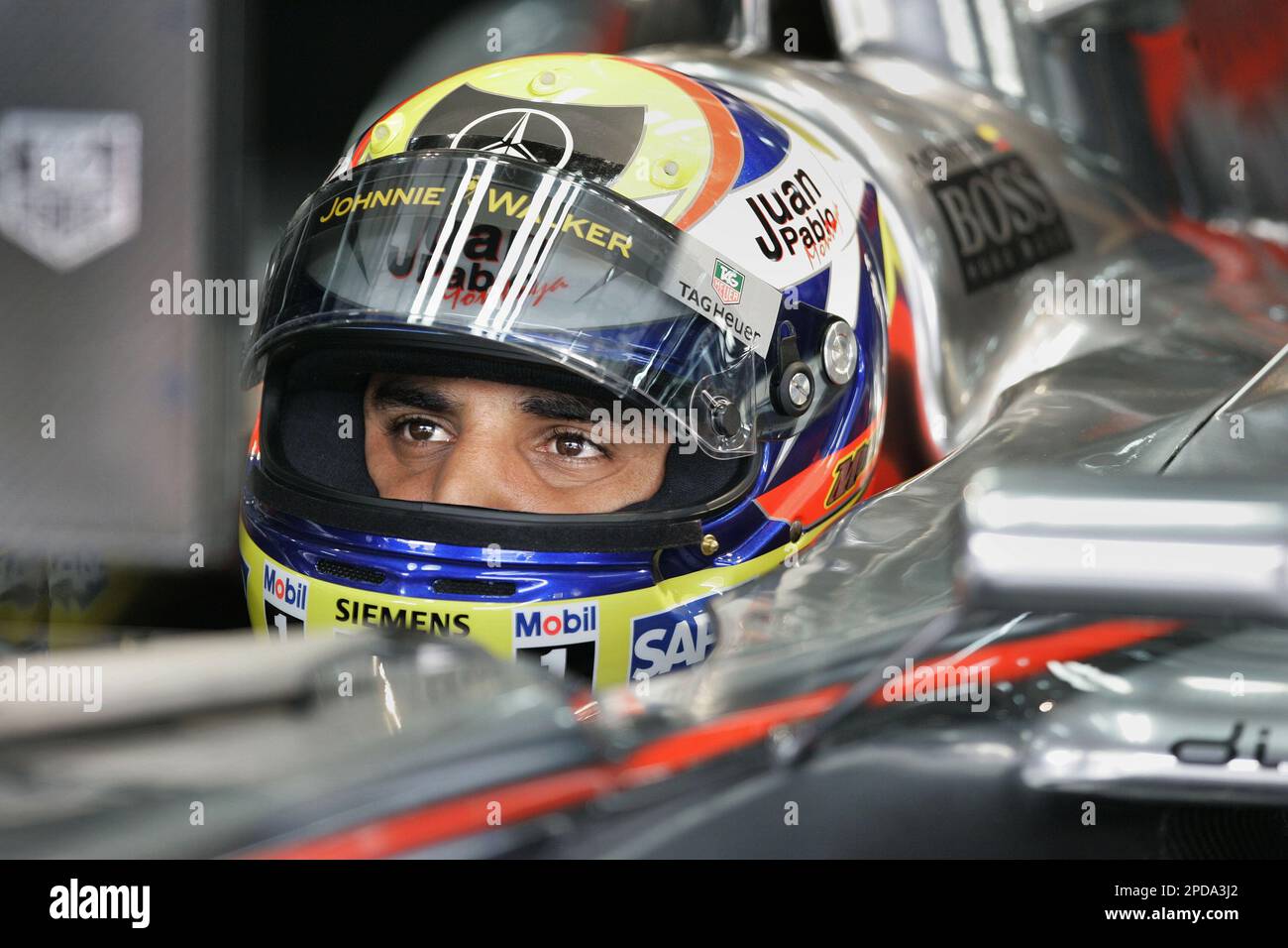 Juan Pablo Montoya of Colombia sits in the cockpit of his McLaren ...
