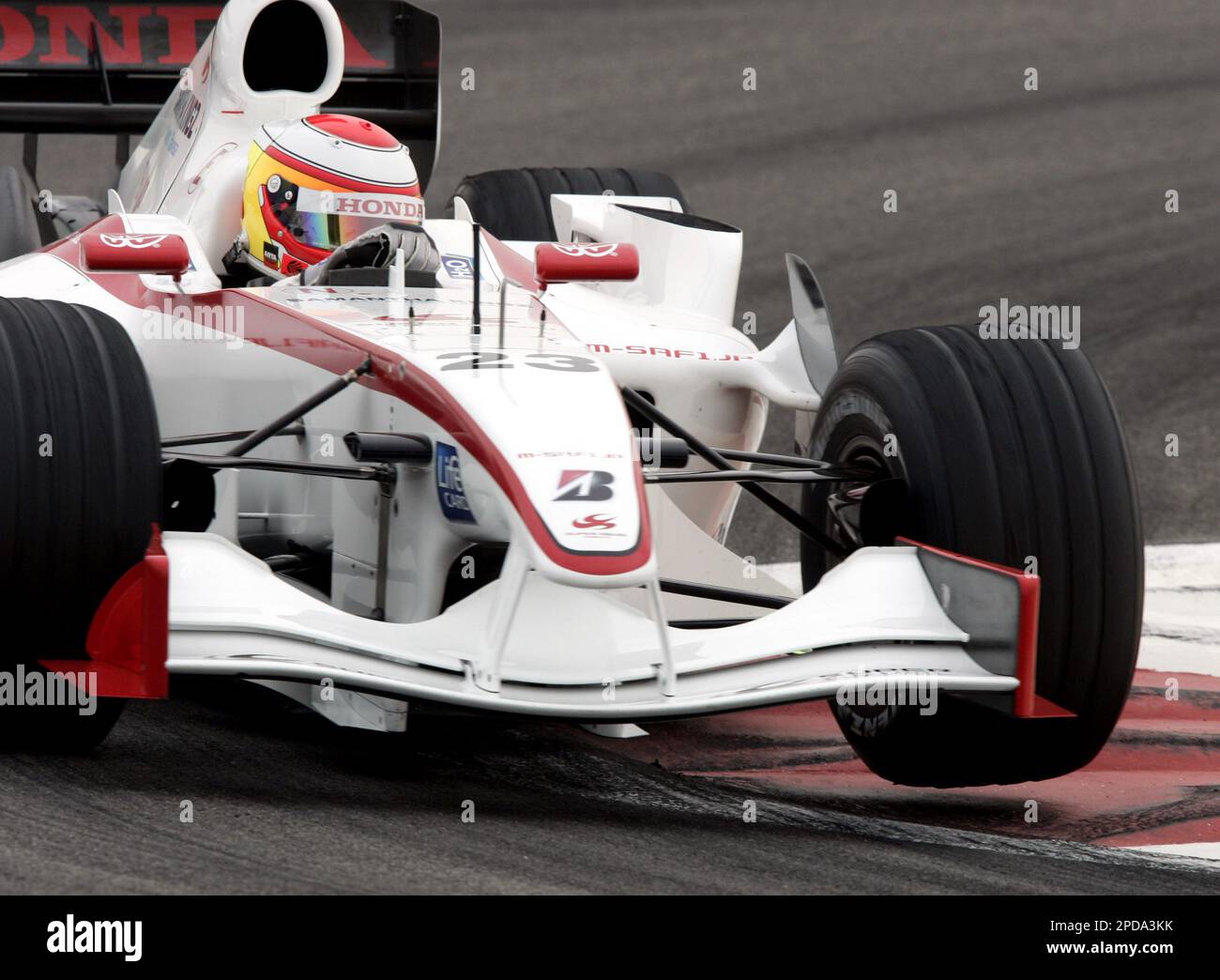 Japan's Yuji Ide takes a curve as he steers his Super Aguri racer ...