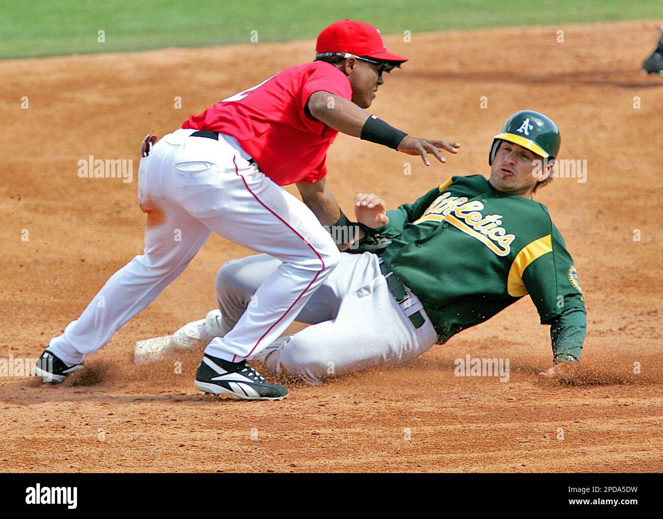 Oakland Athletics' Mike Rouse slides safely under the tag of Los ...