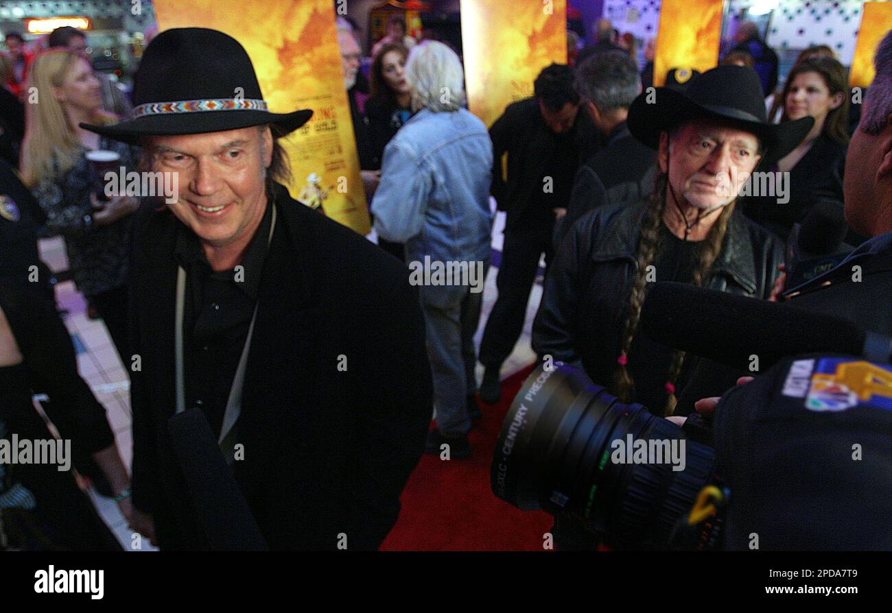 Neil Young, left, and Willie Nelson are interviewed on the red carpet ...