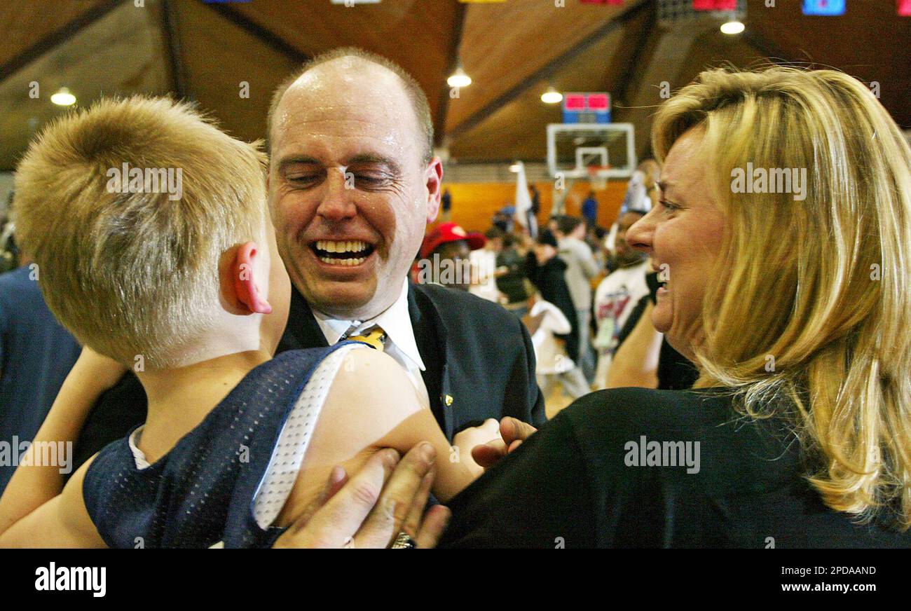 Monmouth coach Dave Calloway, center, celebrates winning the Northeast ...