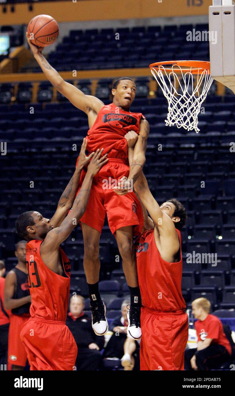 Georgia's Billy Humphrey, top, gets a lift from teammates Mike Mercer ...