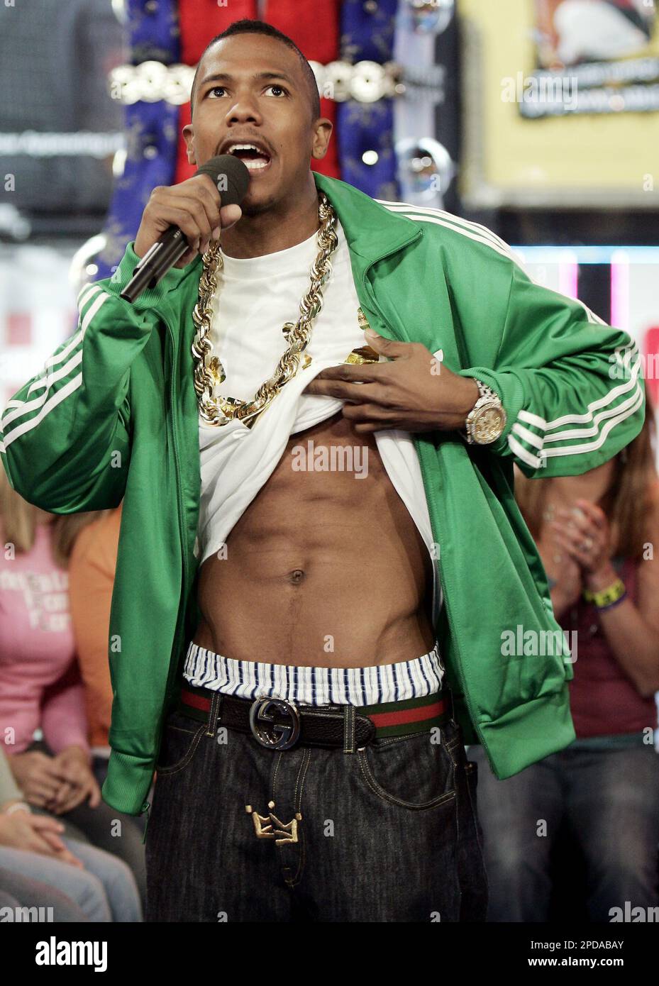Actor and musician Nick Cannon shows his abs as he appears on stage ...