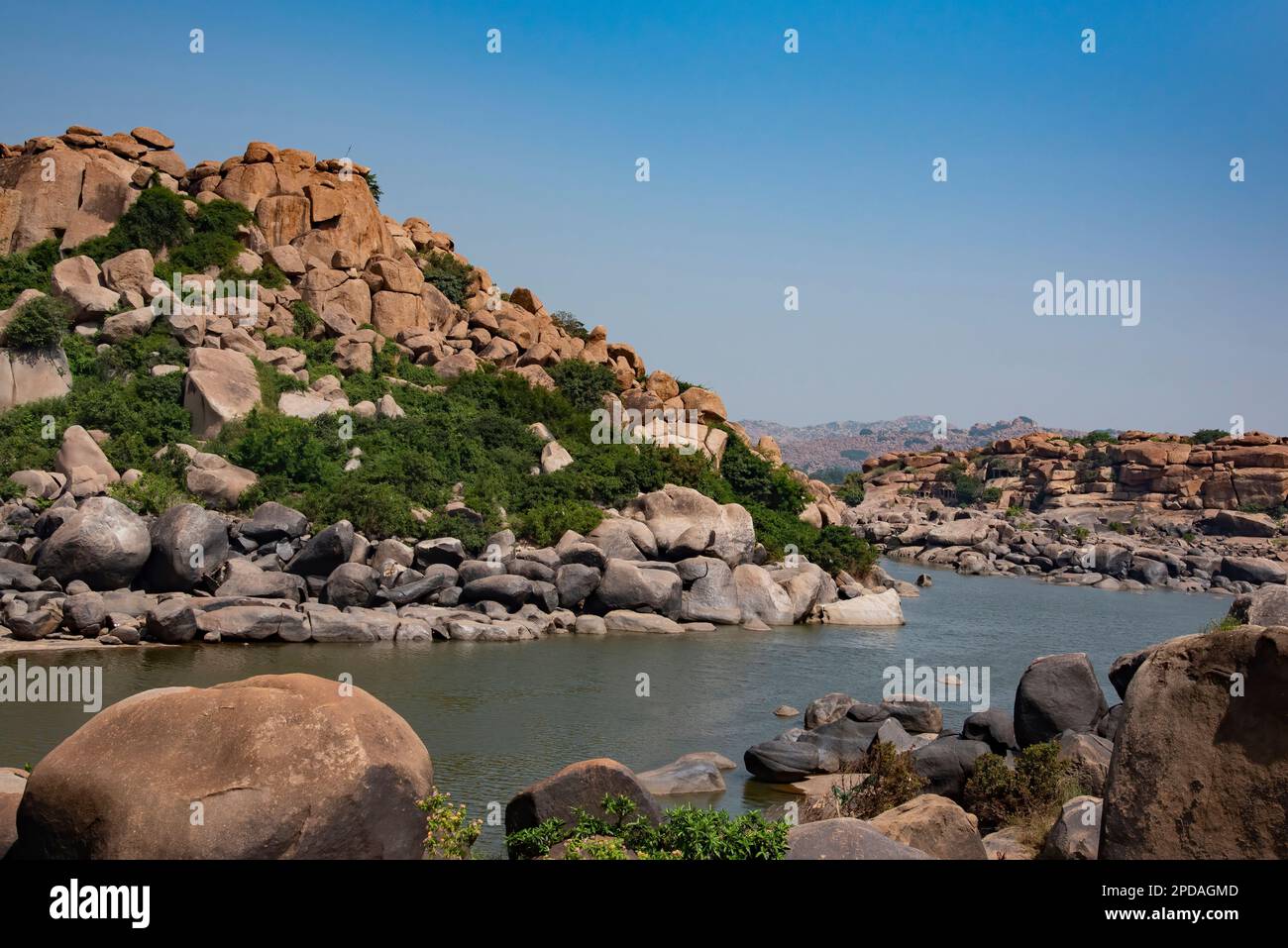 River Tungabhadra flowing through boulder strewn landscape of Hampi ...