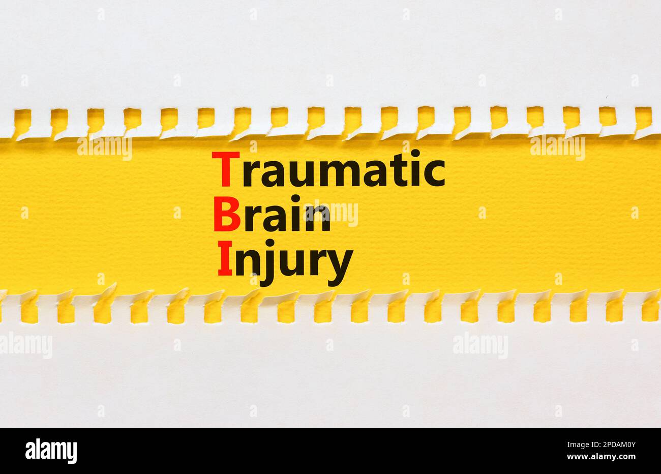 TBI traumatic brain injury symbol. Concept words TBI traumatic brain injury on yellow paper on a ...