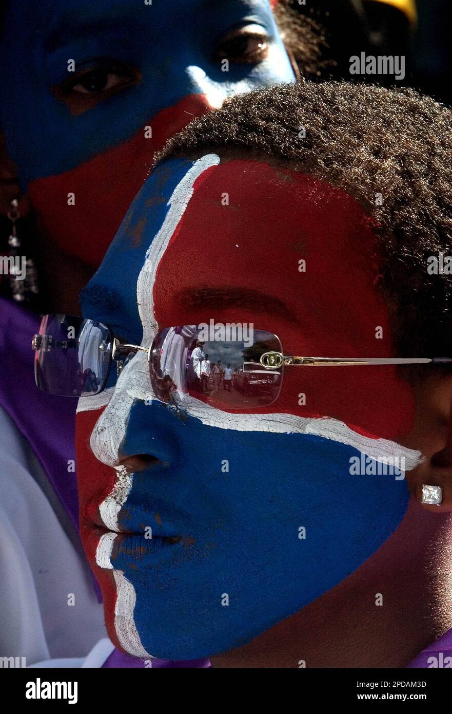 A Dominican boy with his face painted with the Dominican flag,front ...
