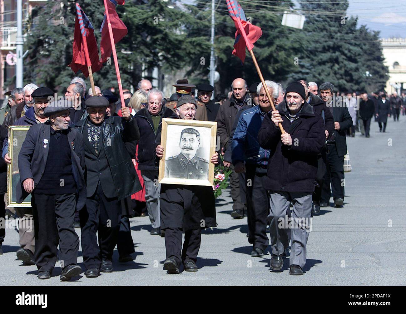 Elderly people carry portraits of the Soviet dictator Josef Stalin and ...