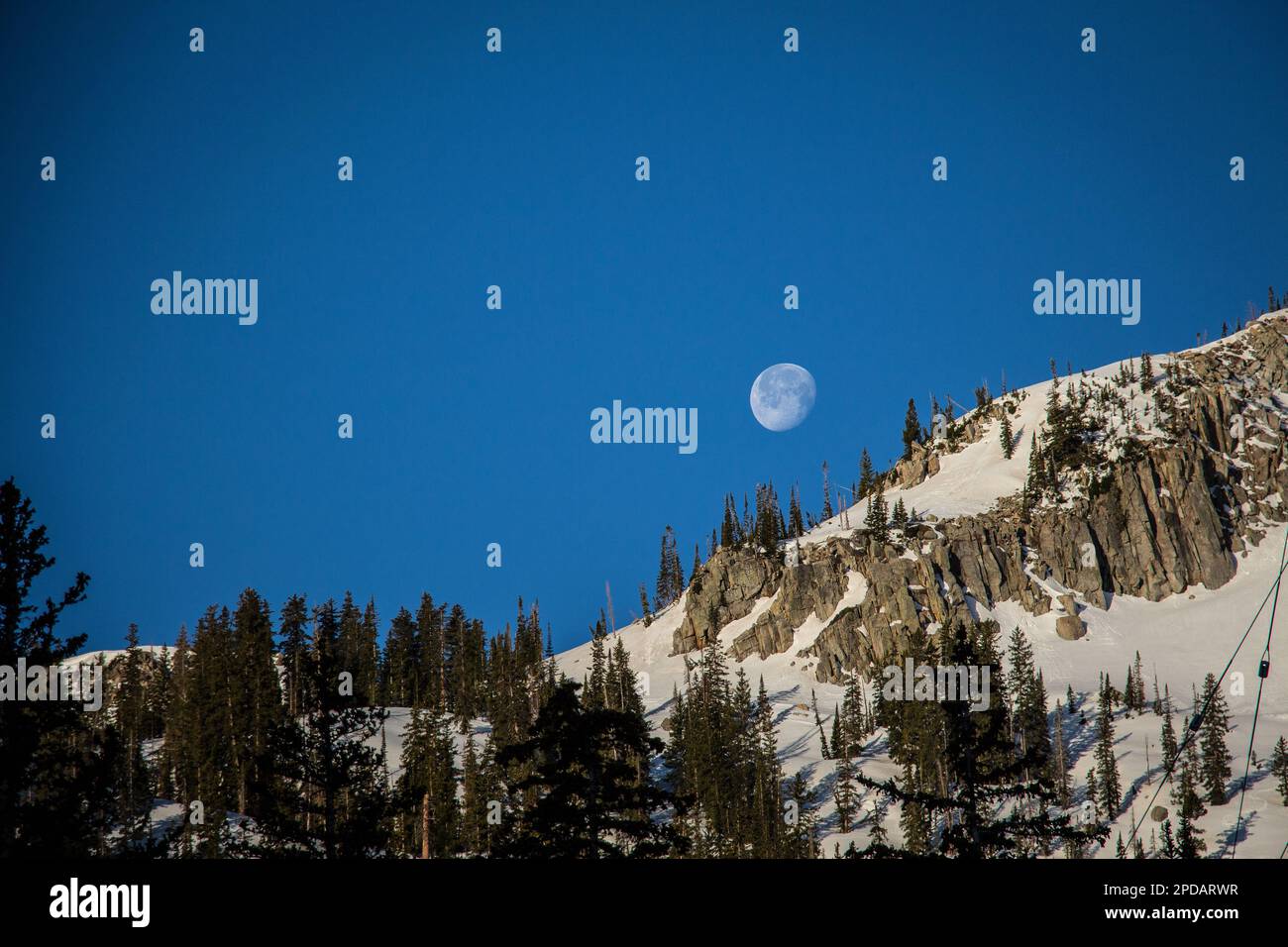 moon rise over mountain peak Stock Photo - Alamy