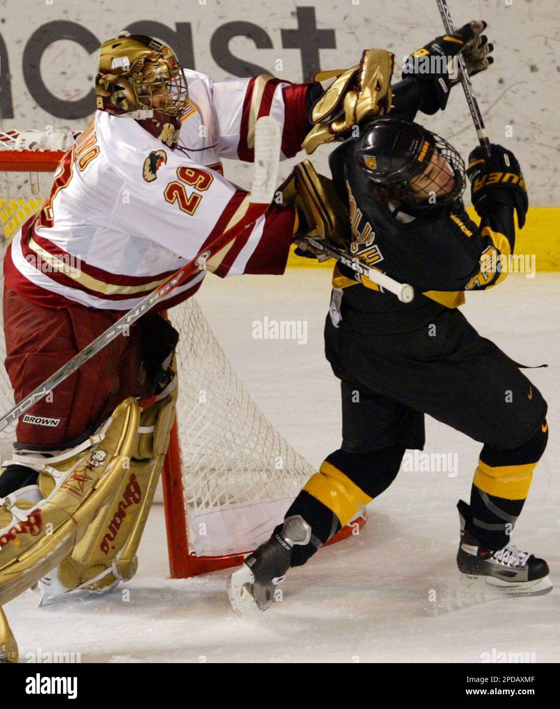 Denver goaltender Peter Mannino (29) pushes Colorado College center ...