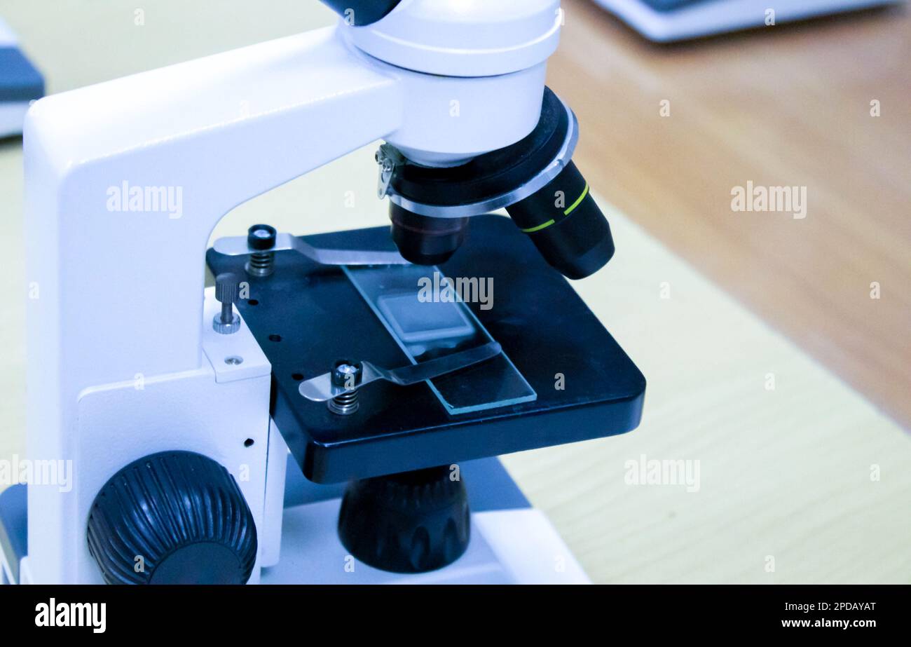 old microscope isolated on white background Stock Photo - Alamy