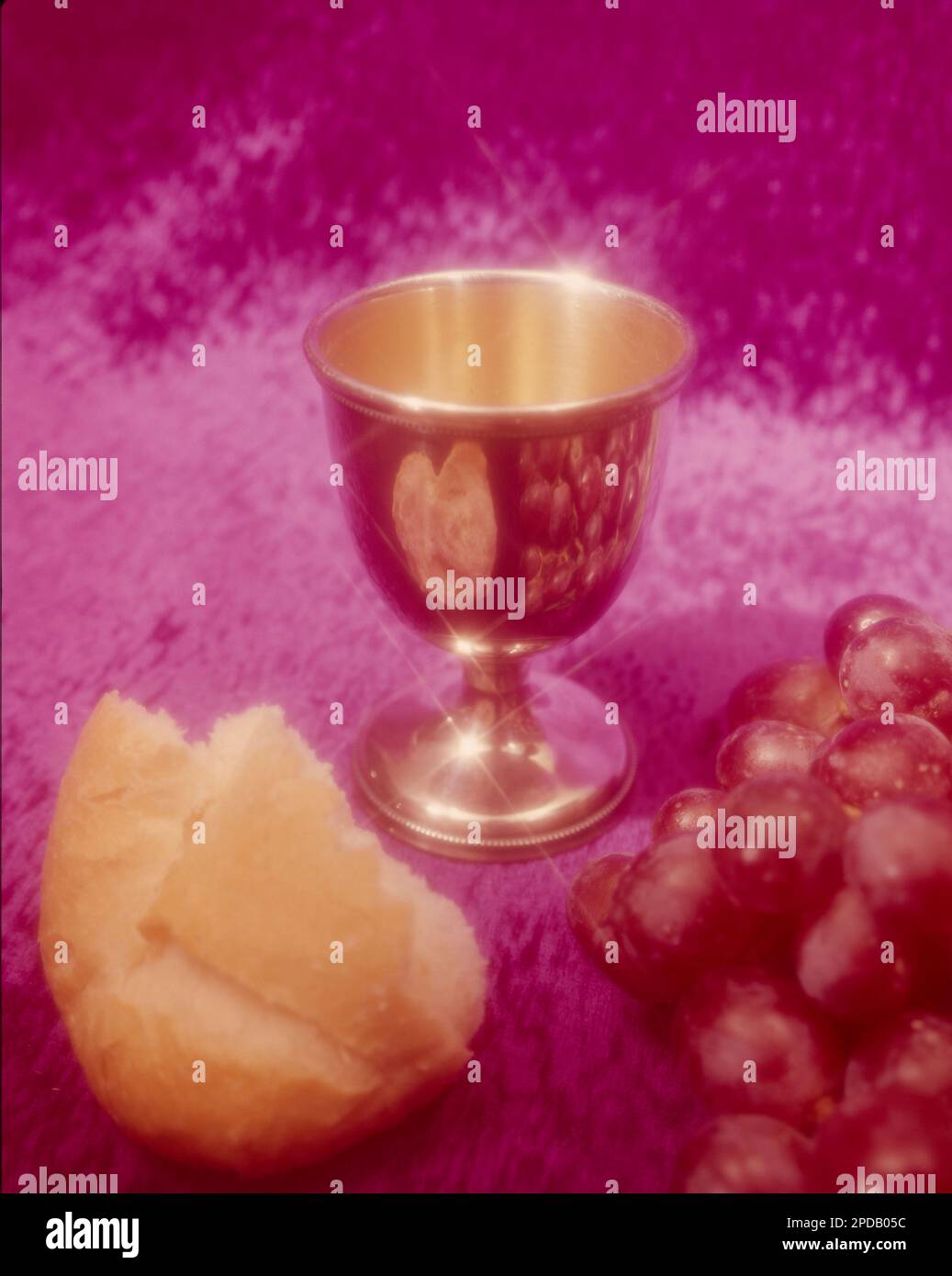 Still life of empty wine chalice grapes and a piece of bread depicting ...