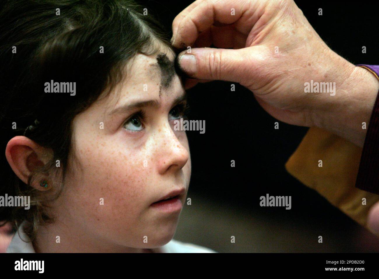 Deja Thomas, 9, from the St Francis Cathedral School, gets ashes from ...
