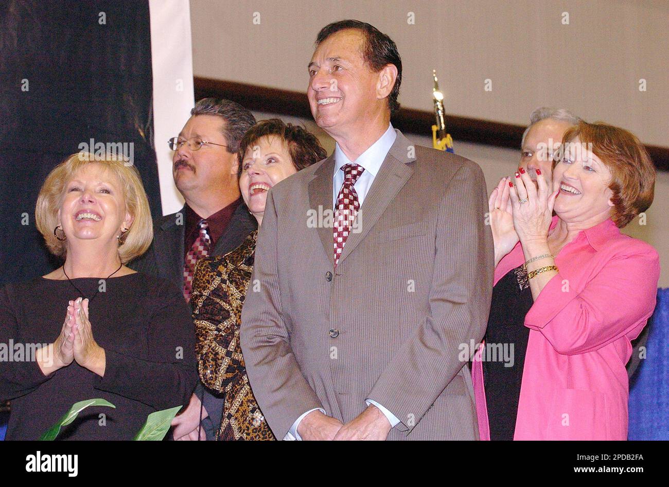 Forrest Lucas, center, co-owner of Lucas Oil Products, smiles with ...