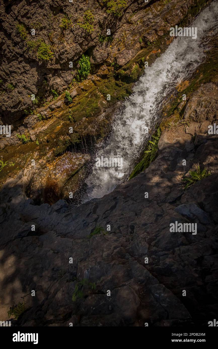 A waterfall dropping into hole in the rocks Stock Photo - Alamy
