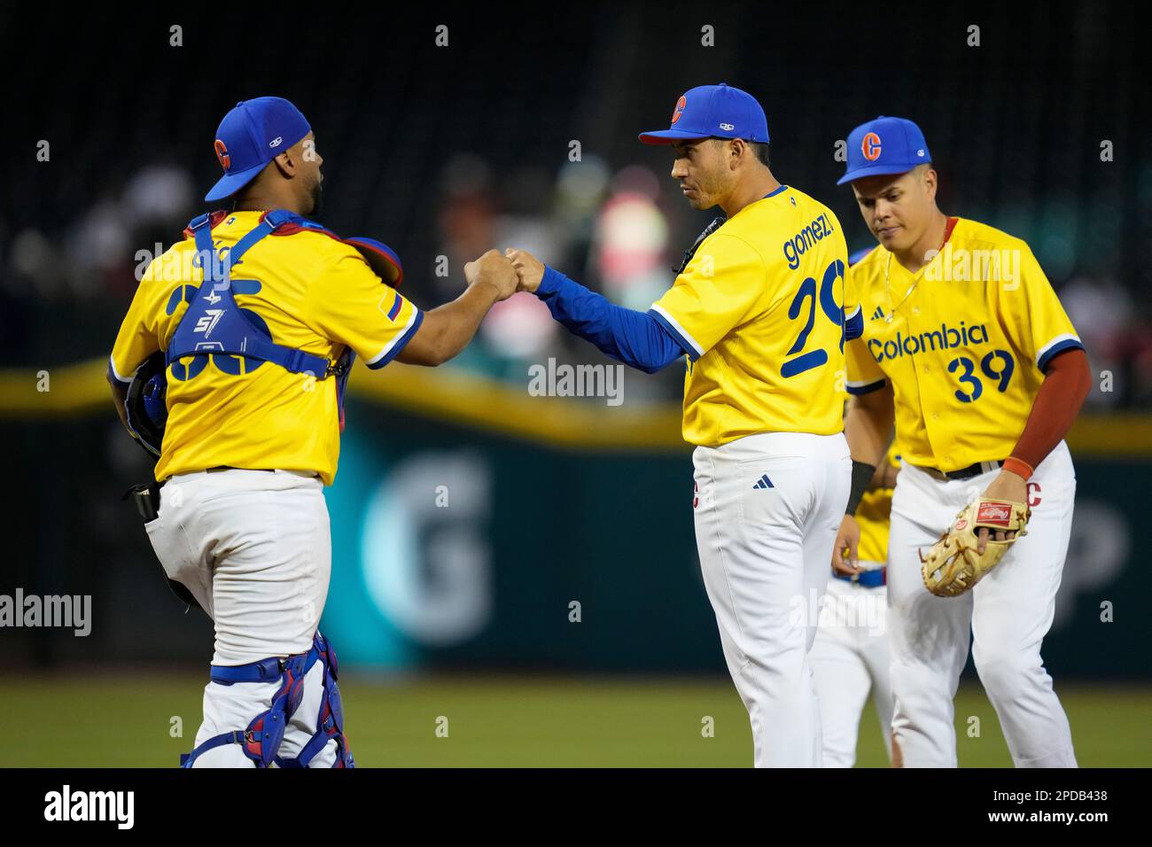 Colombia pitcher Rio Gomez (29) fist bumps catcher Elías Díaz as he ...