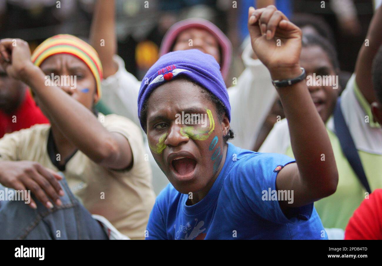 Papuan protesters shout slogans during a demonstration outside a ...