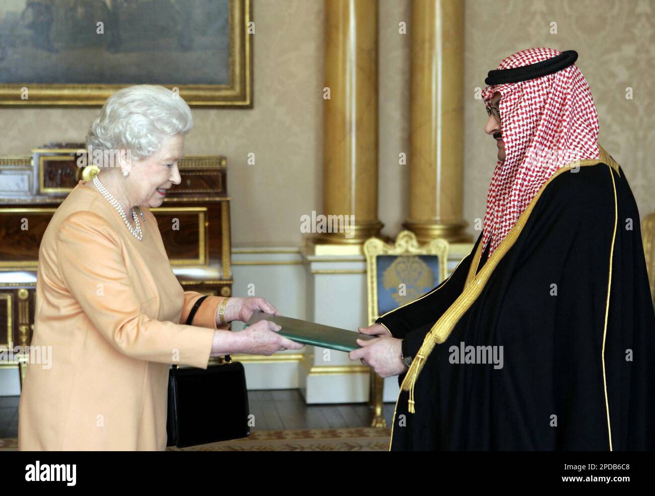 Britain's Queen Elizabeth II, left, accepts a letter of commission from ...