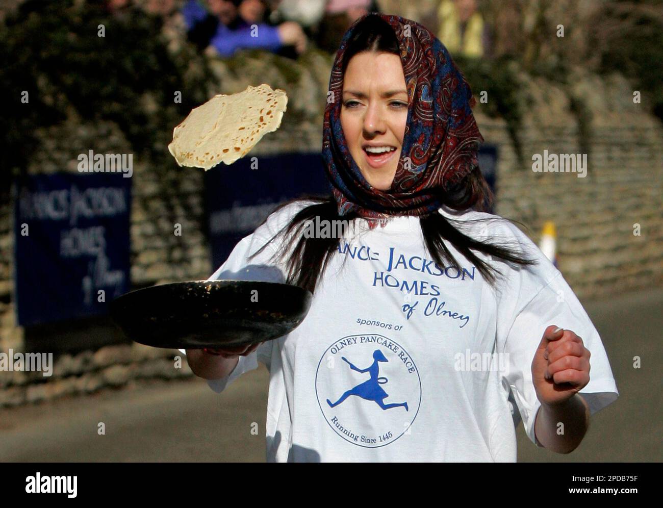 A competitor takes part in the annual Olney Pancake Race to mark Shrove ...
