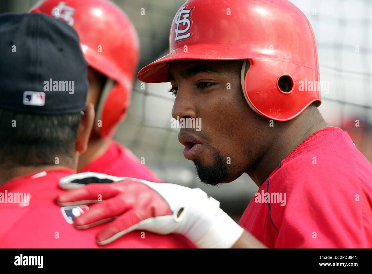 St. Louis Cardinals infielder Hector Luna, right, talks to teammates ...
