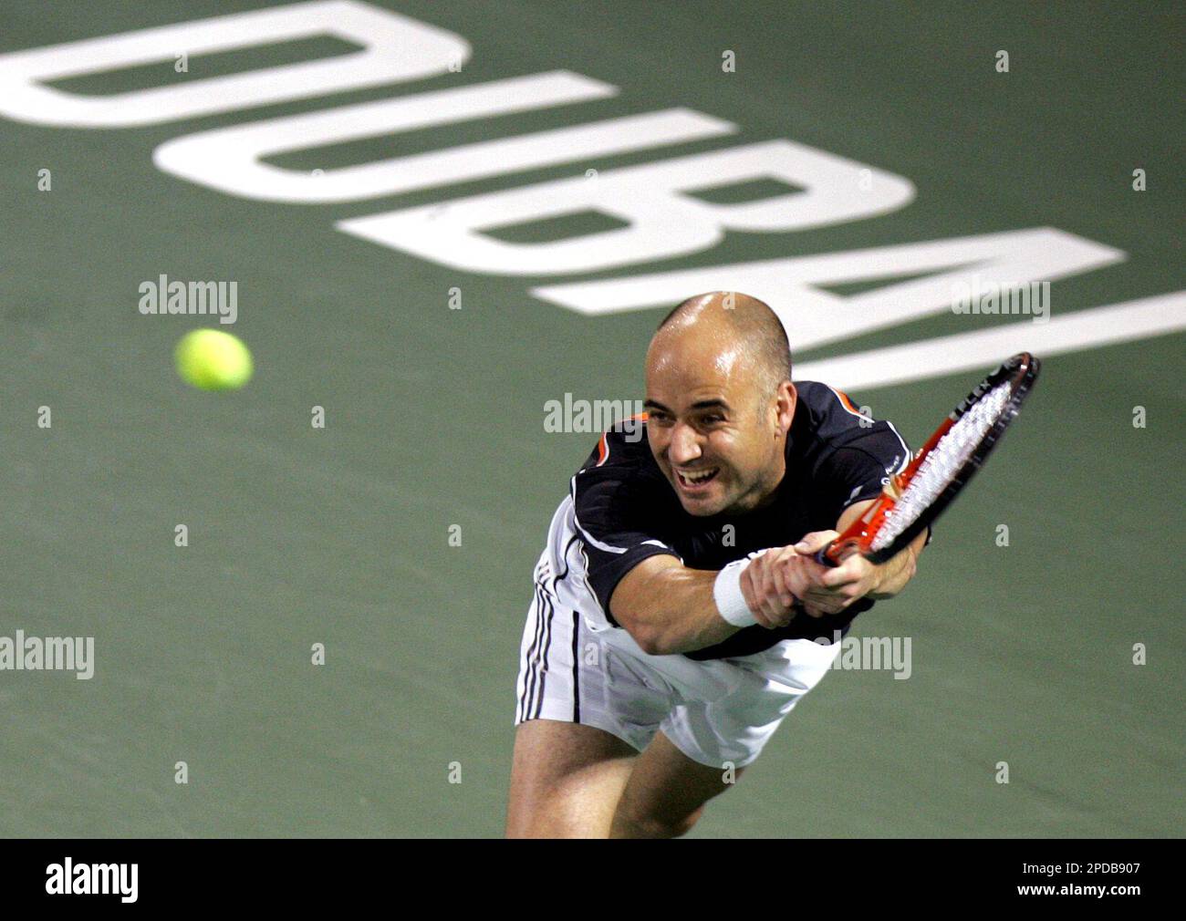Andre Agassi from the United States returns a double backhand to Great ...