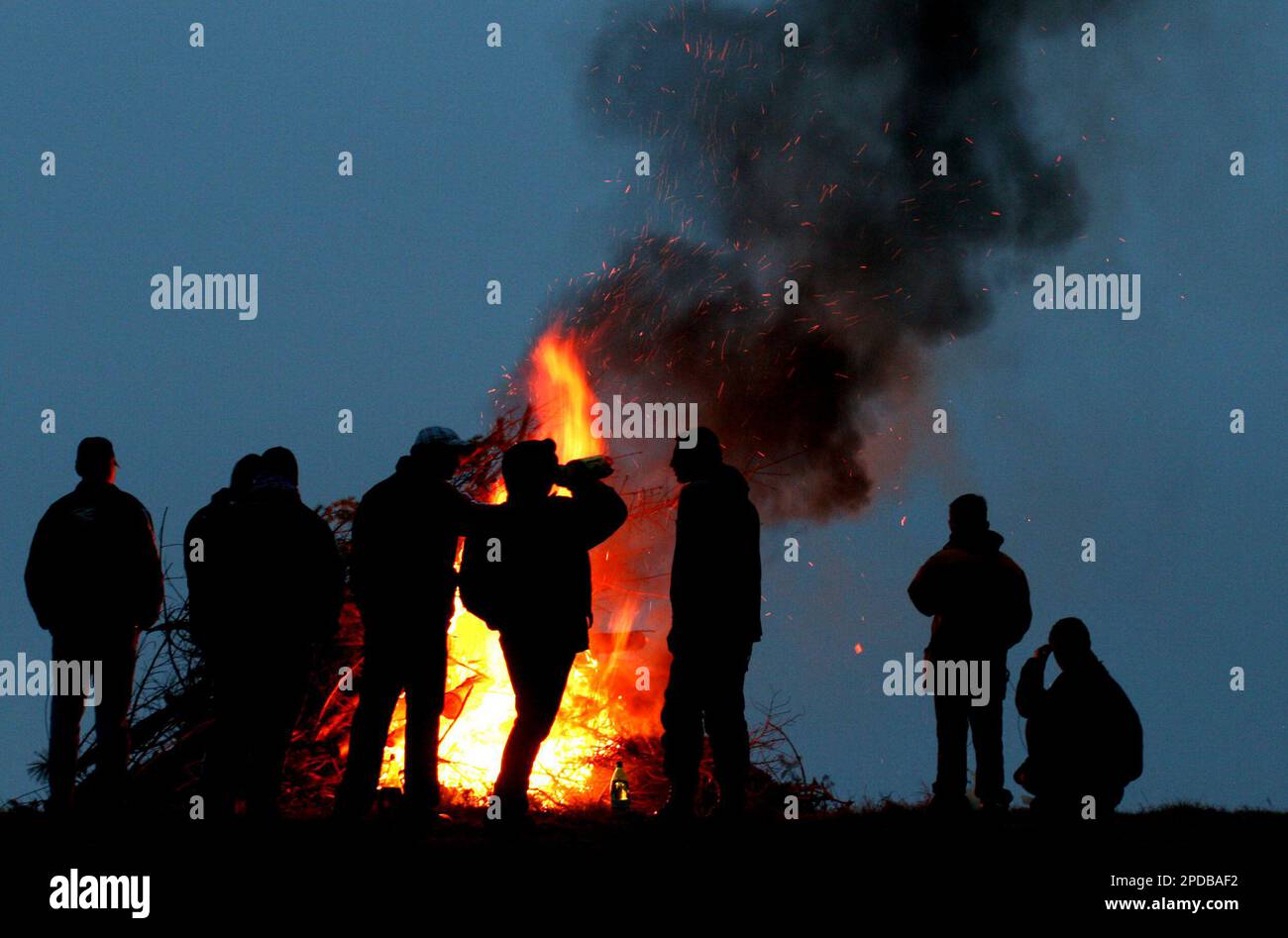 Bulgarians watch a bonfire burn during celebration of "Mesni Zagovezni ...