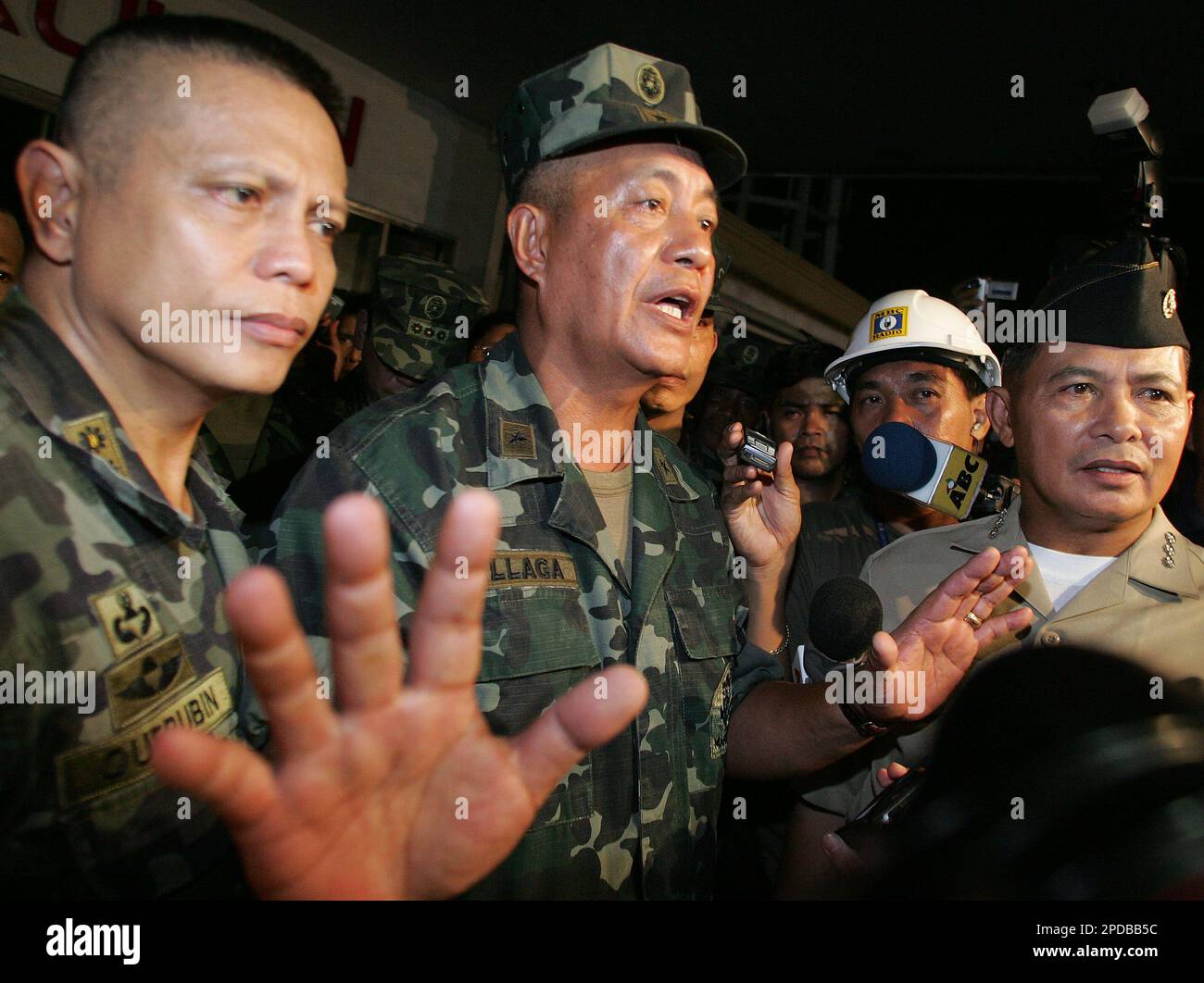 New marine commander, Brig. Gen. Nelson Allaga, center, talks beside ...