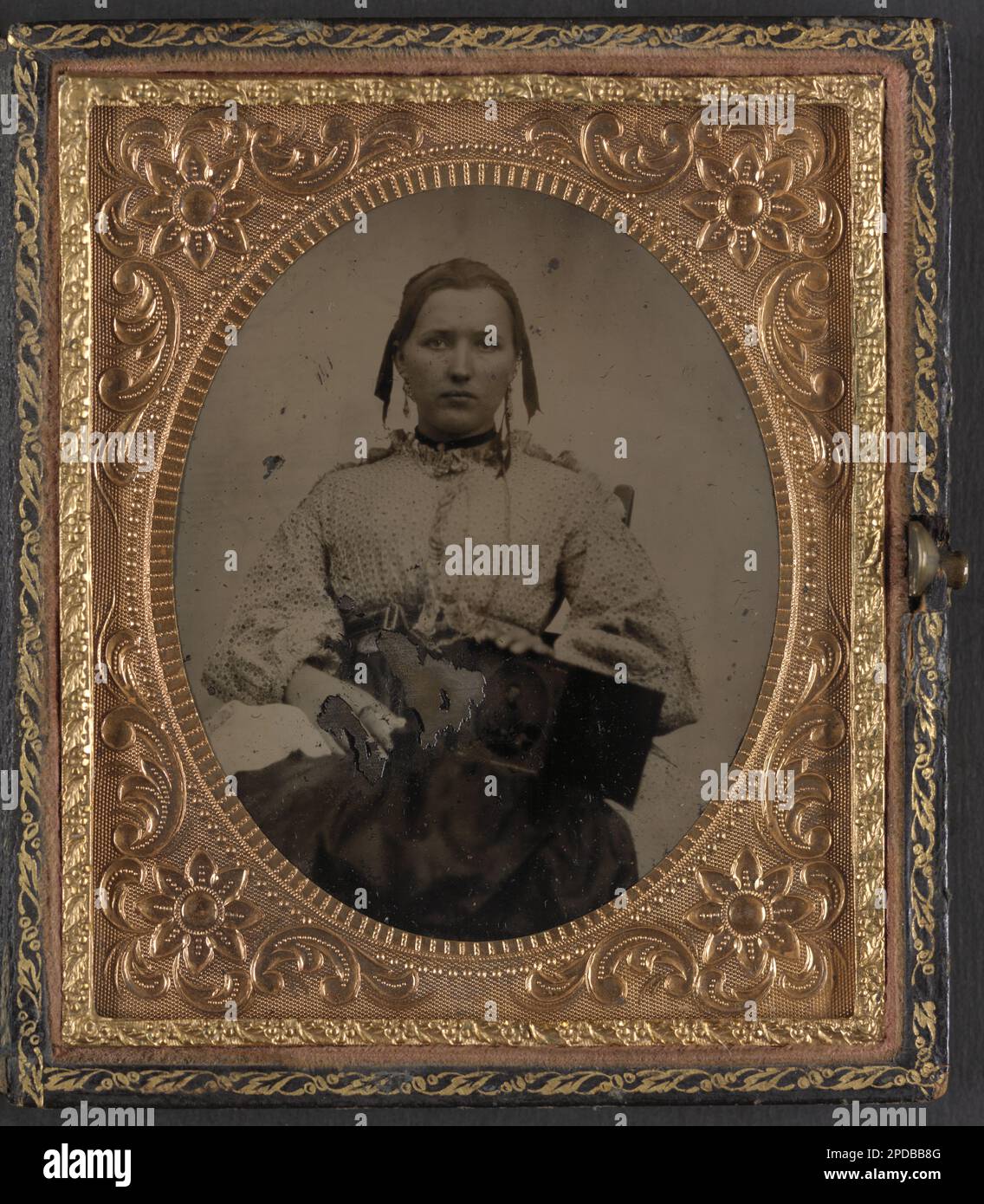 Sabria Clack holding cased photograph of her husband, Private W.R. Clack, of Co. B, 43rd ...