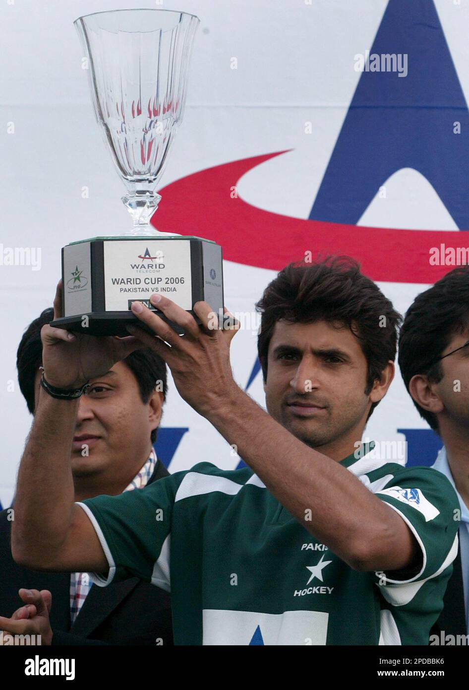 Pakistani hockey teams skipper Muhammad Saqlain raises the winning ...