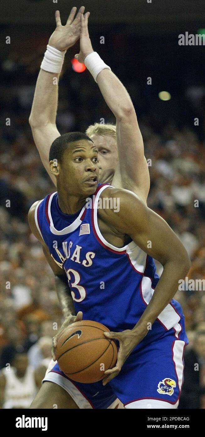Kansas center C.J. Giles, looks to pass after taking an offensive ...