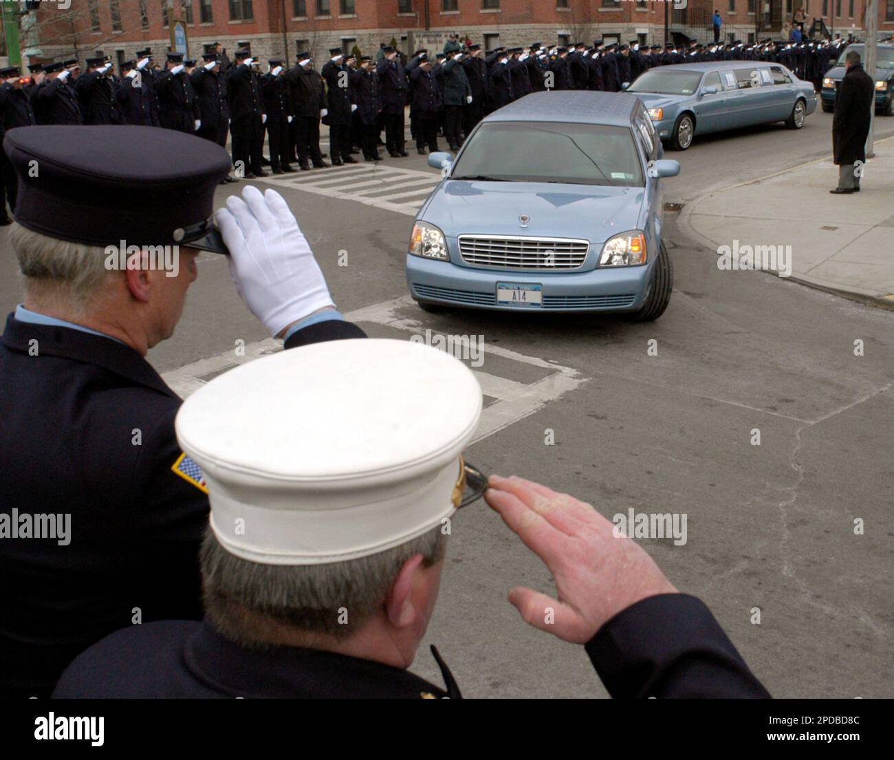 Buffalo Fire Department personnel salute as the hearse carrying ...