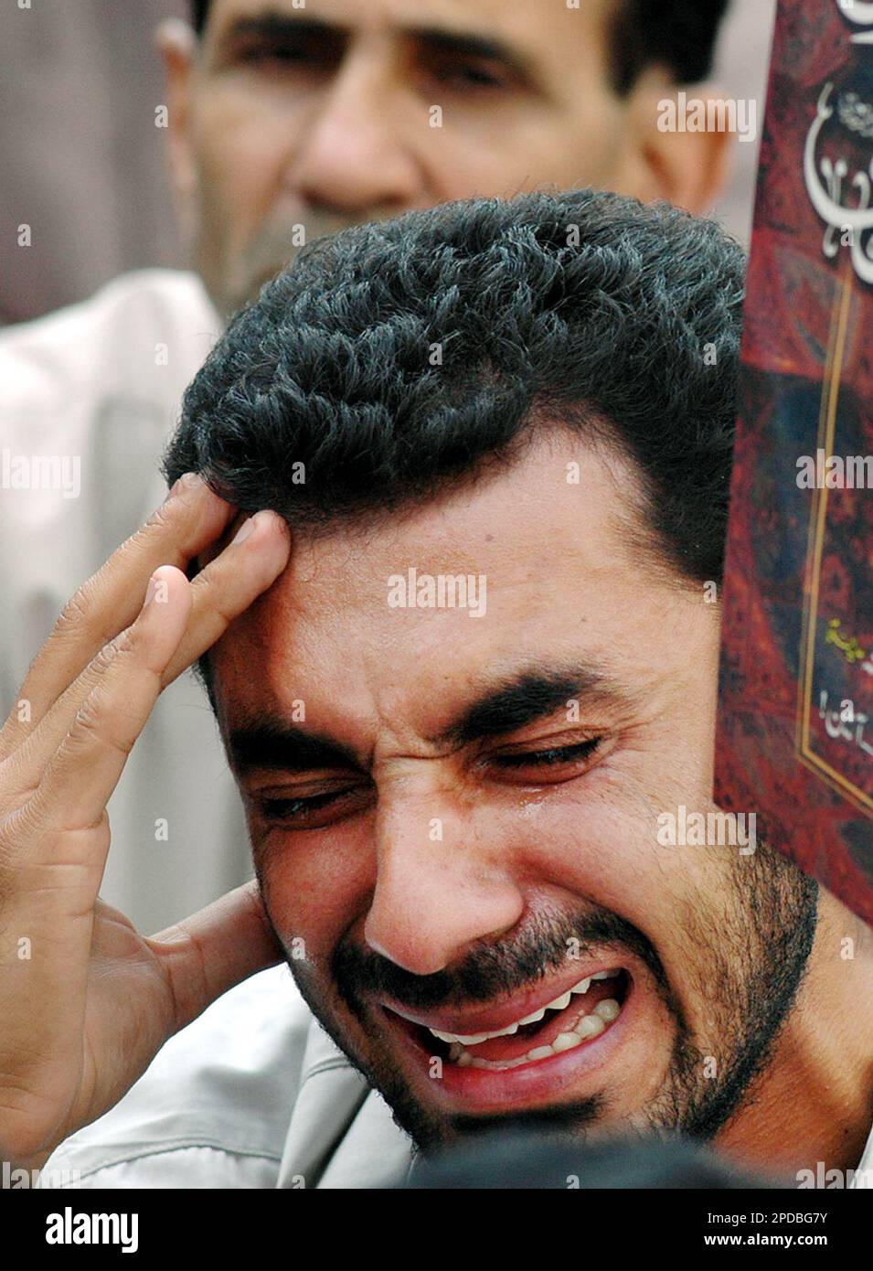 A Pakistani protester cries during a rally to condemn the bombing on ...
