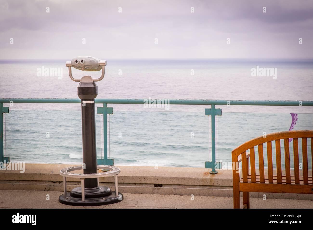 Binoculars and Bench Looking Out Over Ocean Stock Photo - Alamy