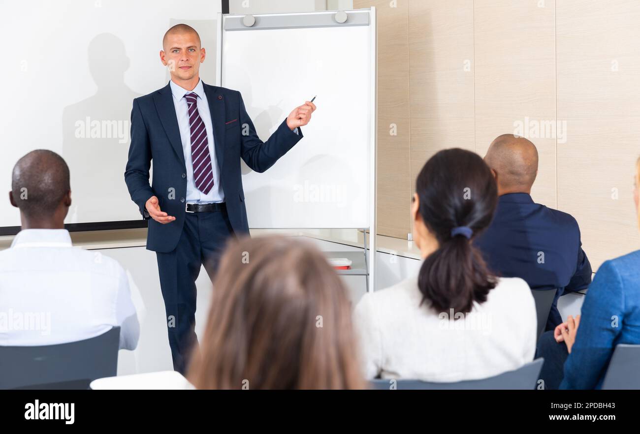Man giving presentation to colleagues at business meeting Stock Photo ...
