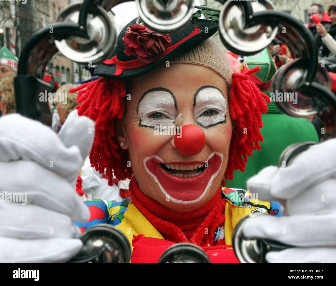 A reveler dressed up as clown celebrates the beginning of this year's ...