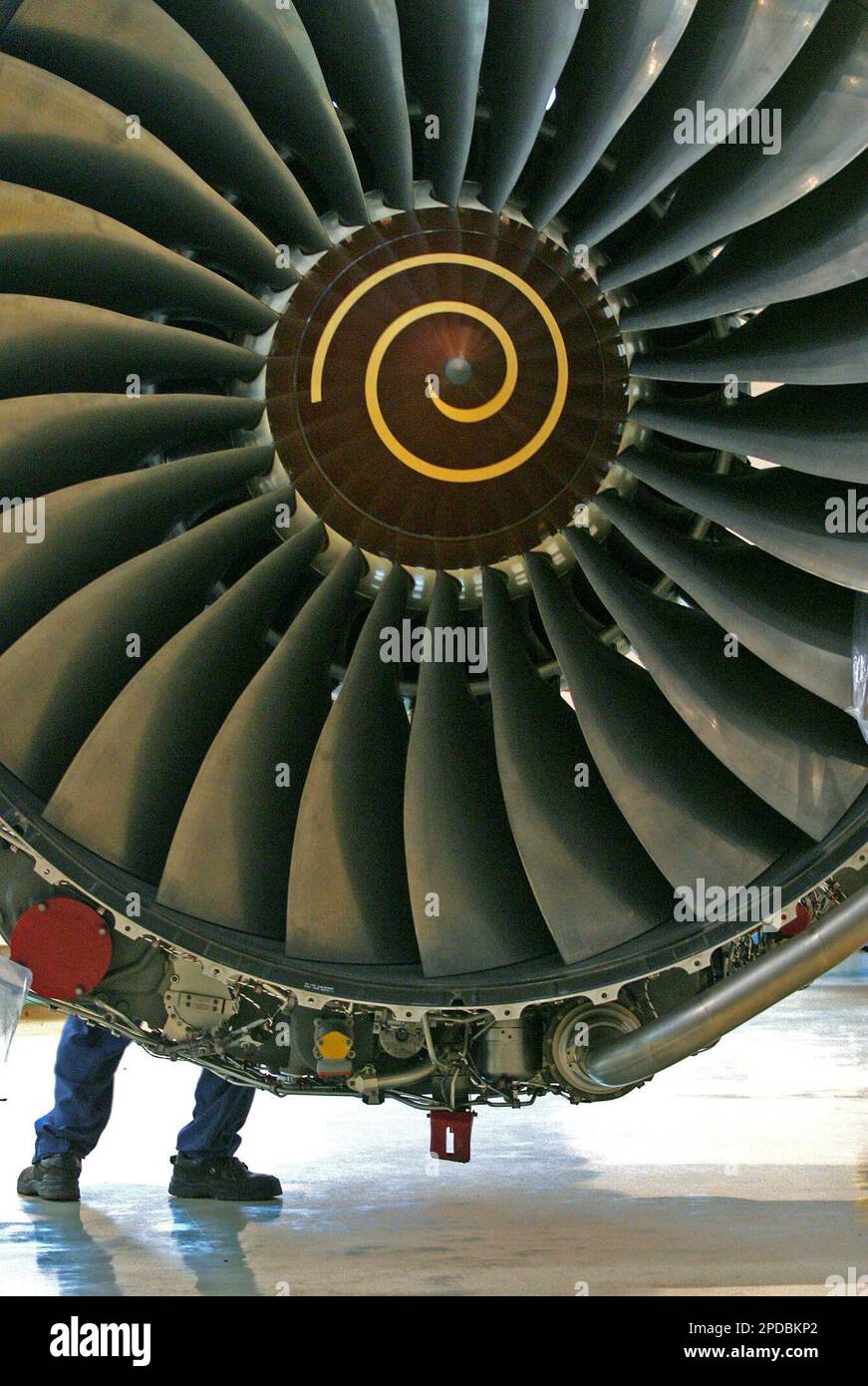 A technicians' feet are seen behind a set of turbine blades casing of a ...