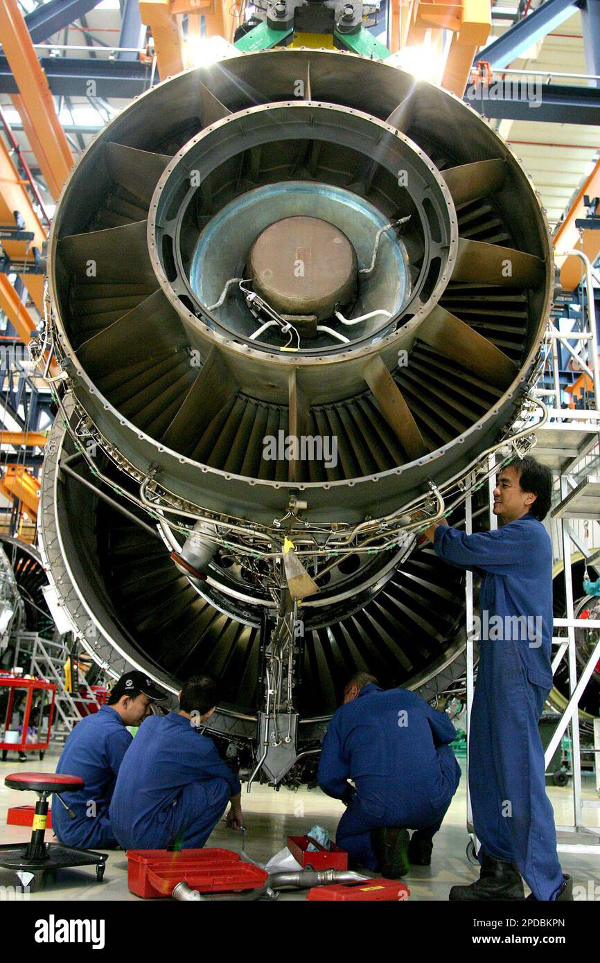 Technicians fix turbine blades casing of a Trent 800 aero plane engine ...