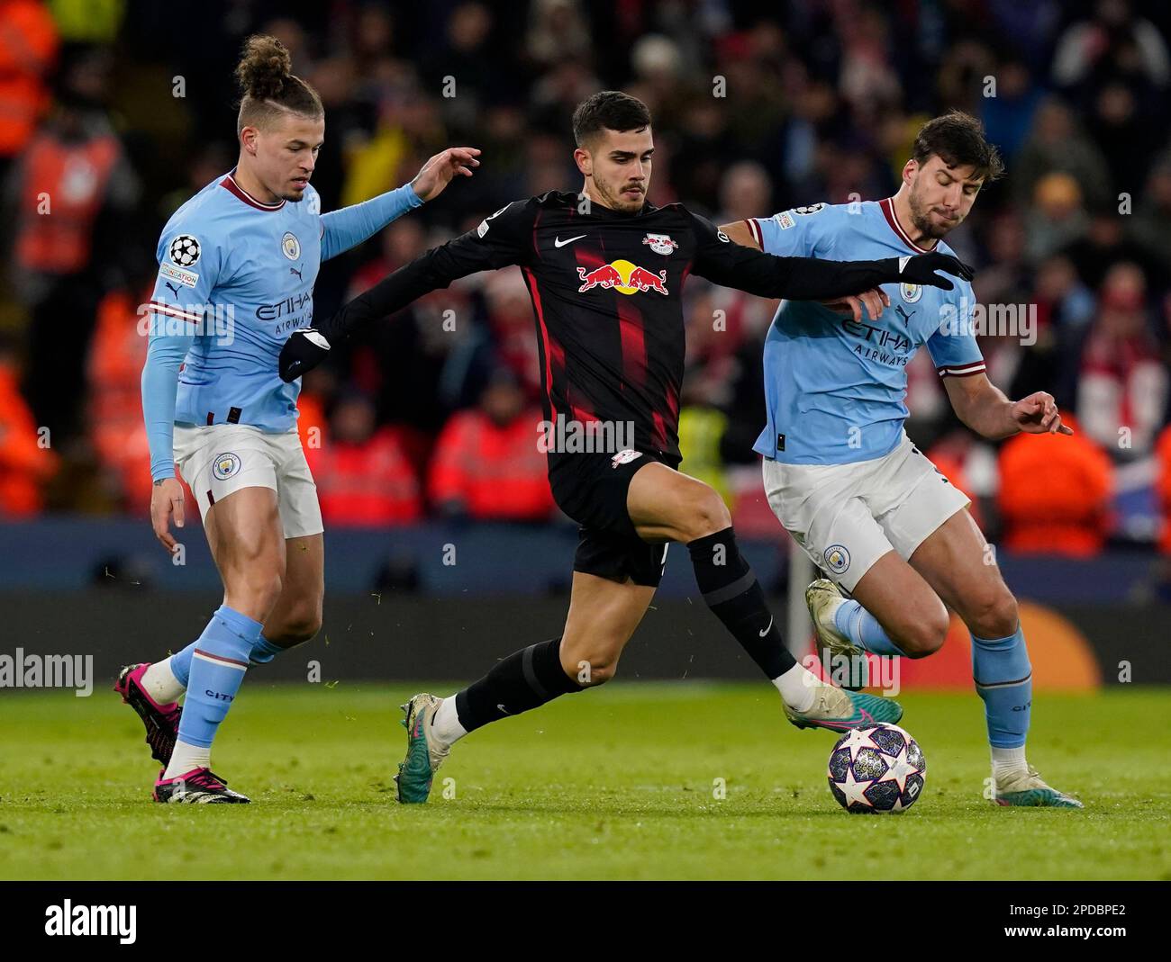 Manchester, UK. 14th Mar, 2023. Andre Silva of RB Leipzig tackled by Kalvin Phillips (l) and ...