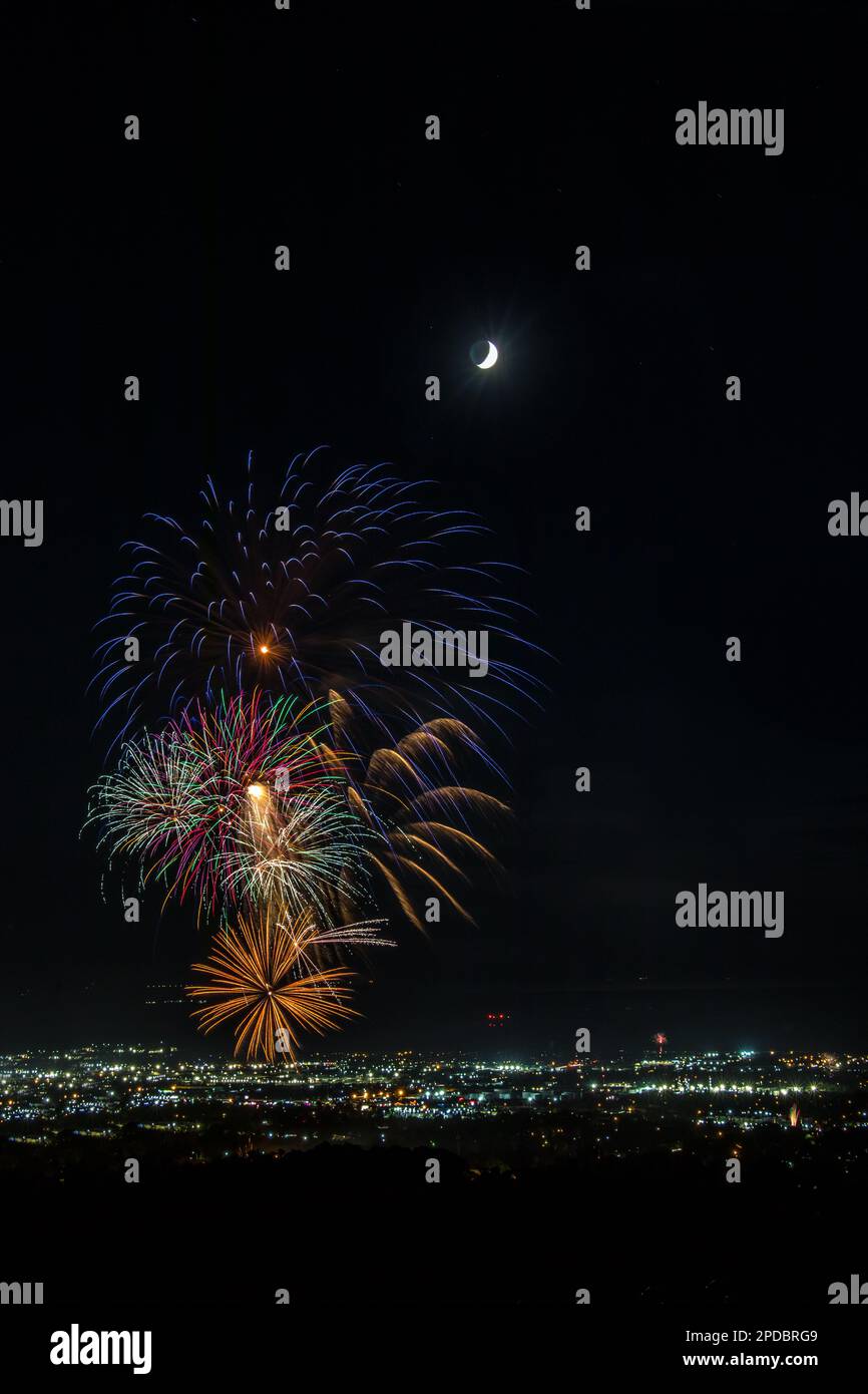 Long exposure of colorful aerial fireworks exploding over over city ...