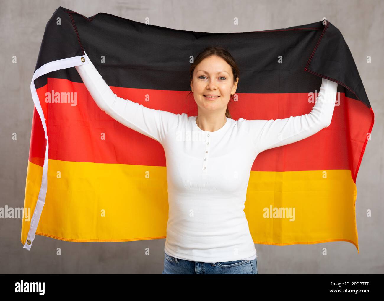 Adult cheerful woman holding Germany flag Stock Photo - Alamy