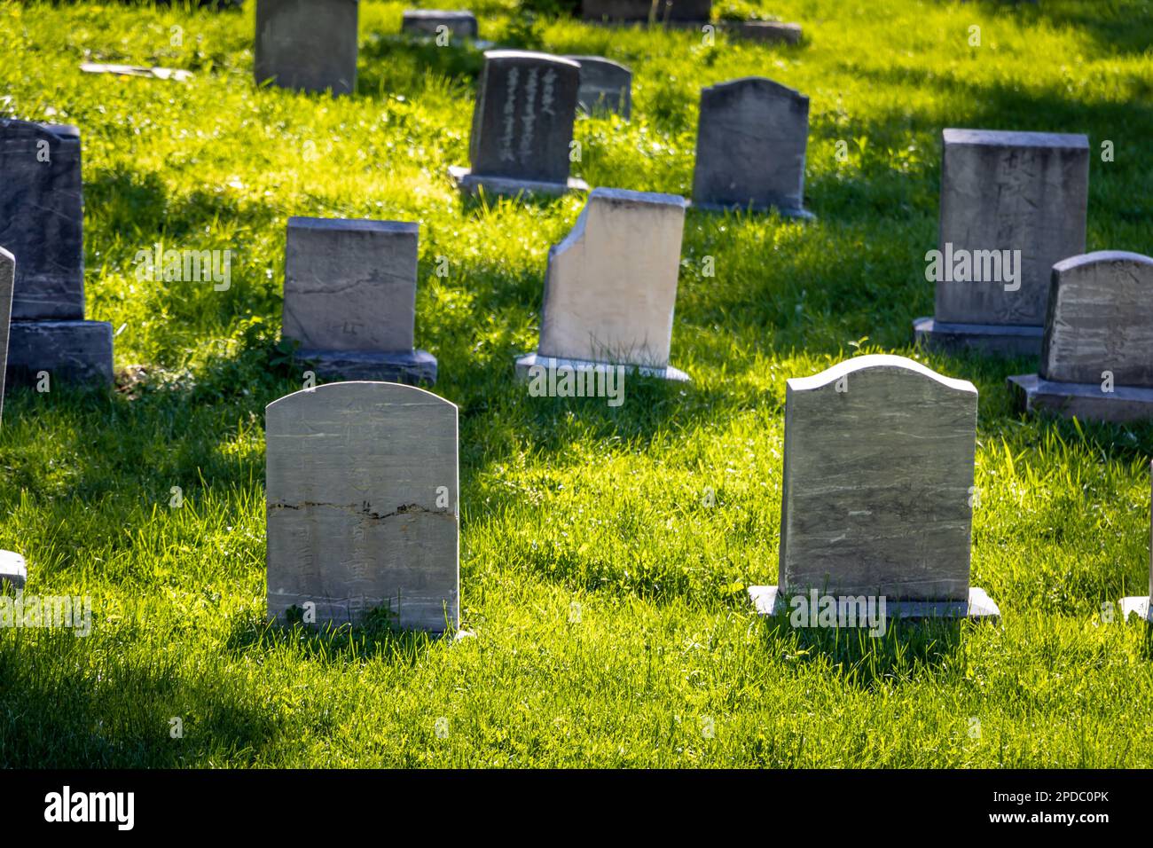 Group of old headstones of graves on the side of a hill Stock Photo - Alamy