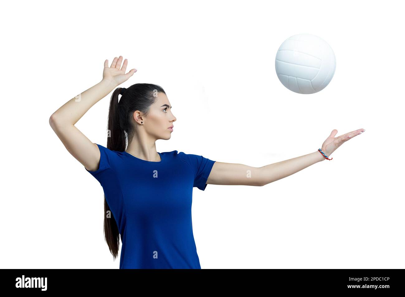 Volleyball girl hold and kick ball in blue costume on white background ...