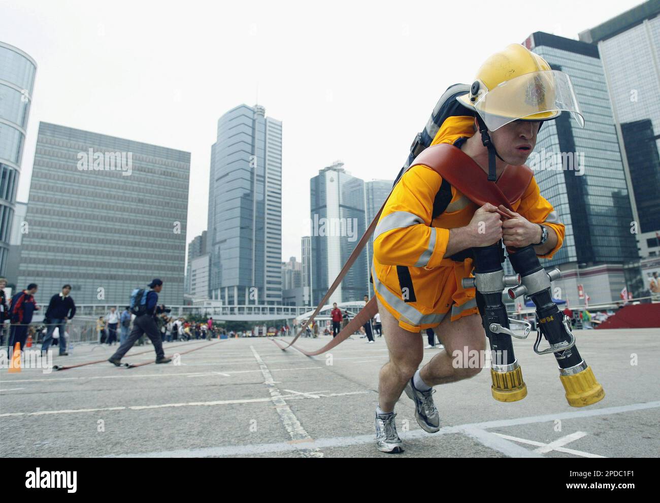 Mathew Schultz, a firefighter from England, expands two lines of hose ...