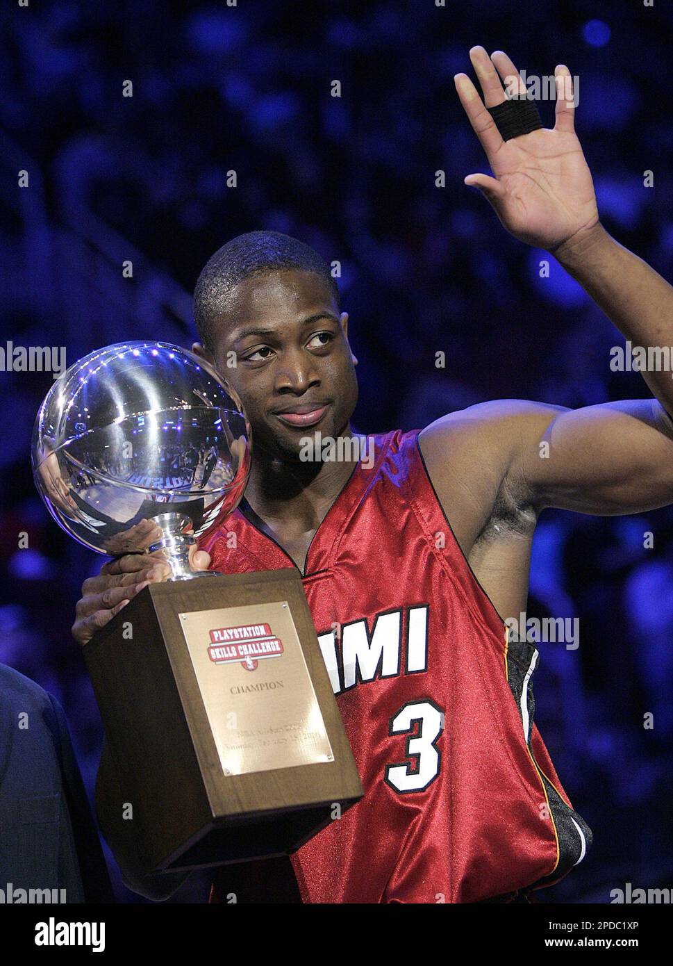 Miami Heat guard Dwyane Wade waves after being presented the trophy for winnng the NBA All-Star ...