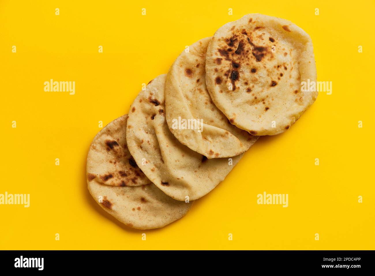 Egyptian bread Aish Baladi on. A lot of fresh bread lies on the yellow ...