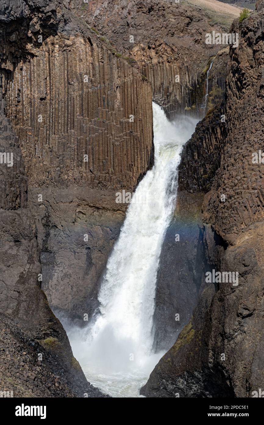 Waterfall Litlanesfoss surrounded by basalt columns in eastern Iceland ...