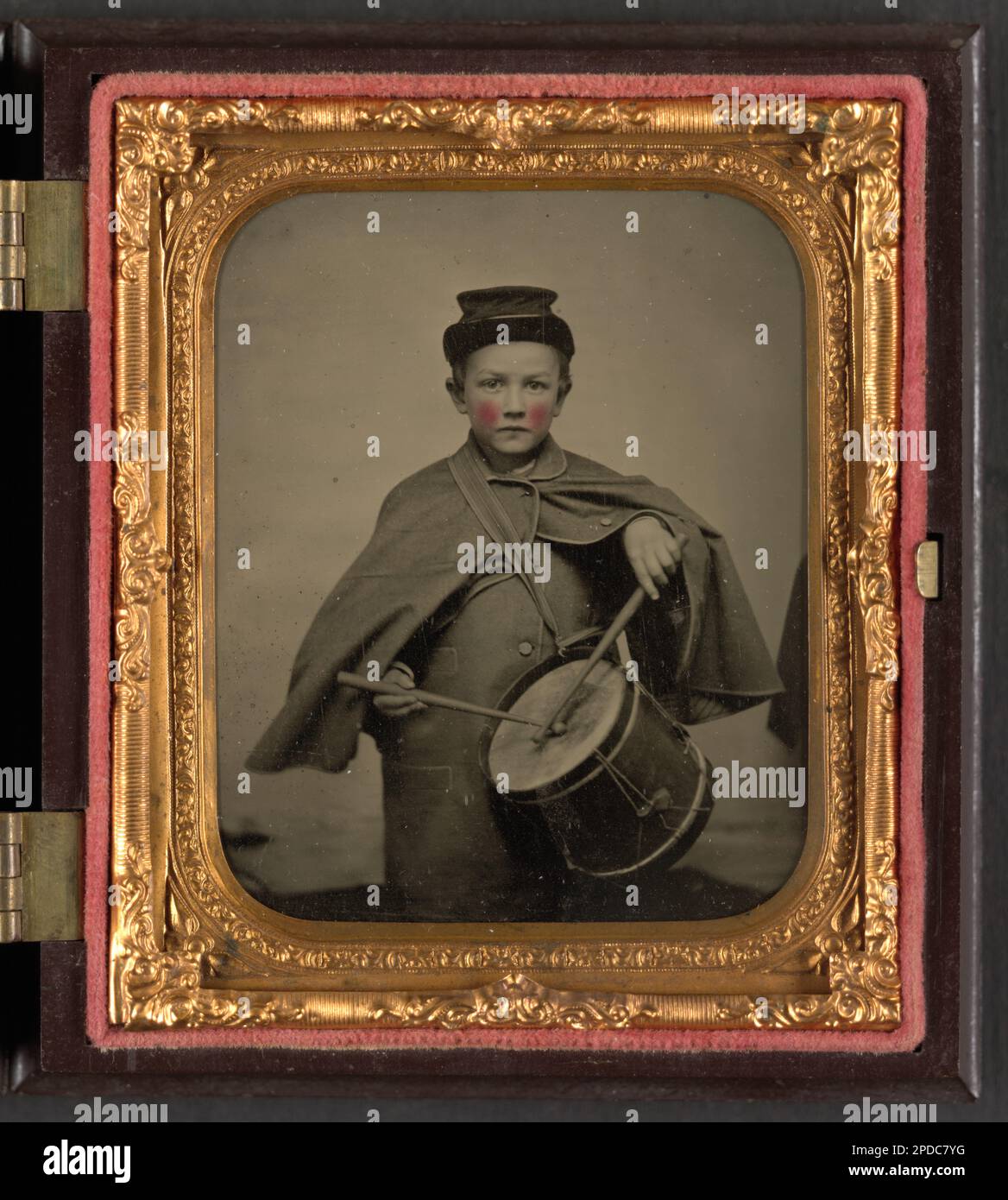 Unidentified young drummer boy in military uniform playing drum ...