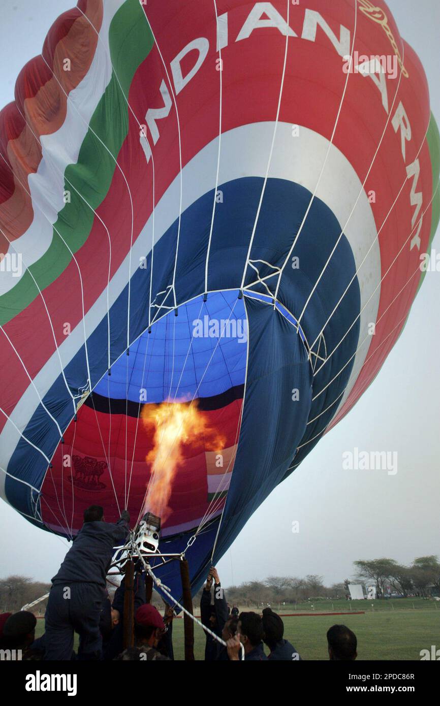 Army Adventure Wing members light a gas burner into a hot air balloon ...