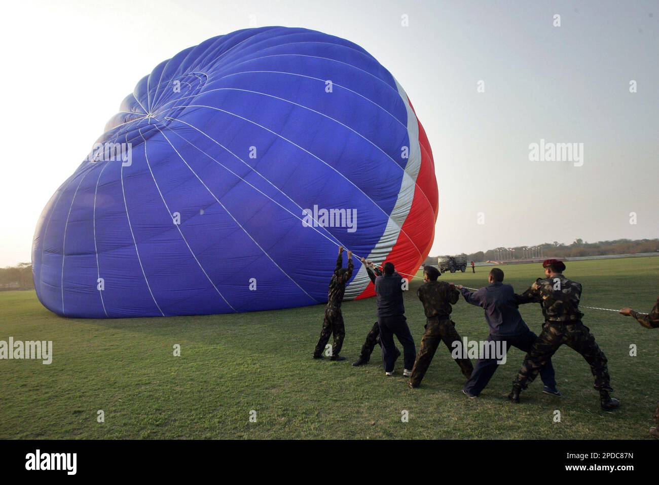 Army Adventure Wing members pull at a hot air balloon in New Delhi ...