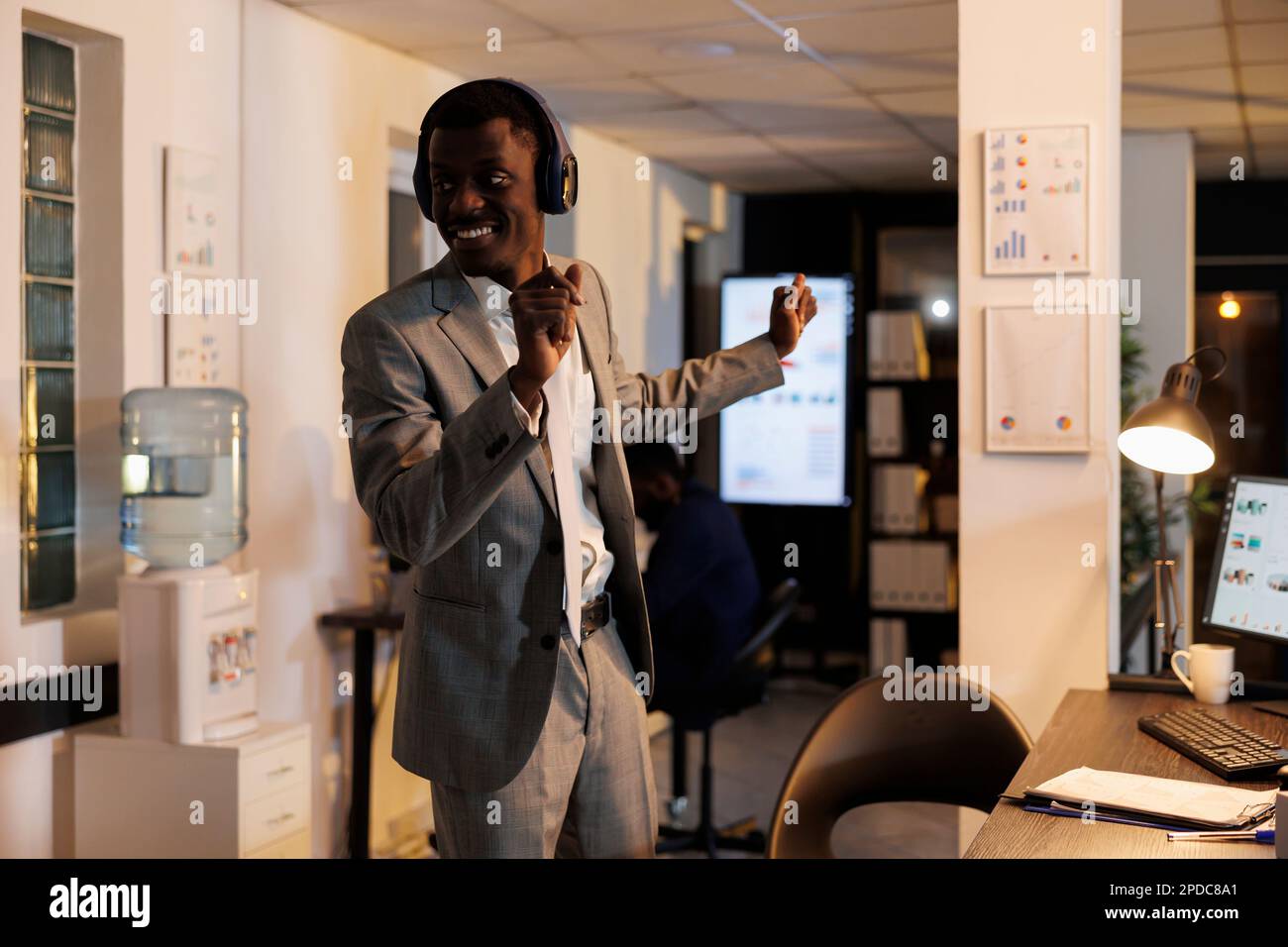 entrepreneur with headphones having fun in startup office, singing and ...